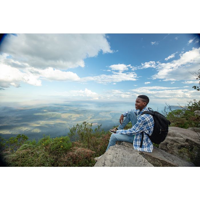 Family - Limpopo - Young boy sitting on rock over valley