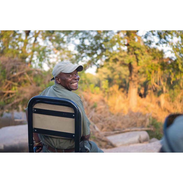 Wildlife Safari-Mpumalanga-Smiling ranger sitting on the tracking seat ...